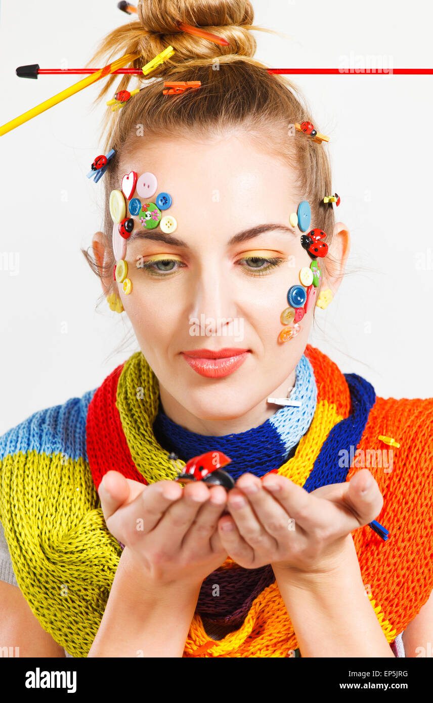 Blond woman with creativity hairstyle with colored buttons and fashion ...