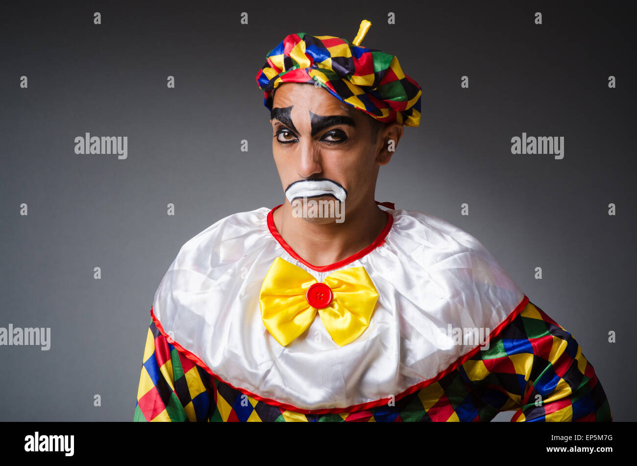 Sad clown against dark background Stock Photo - Alamy