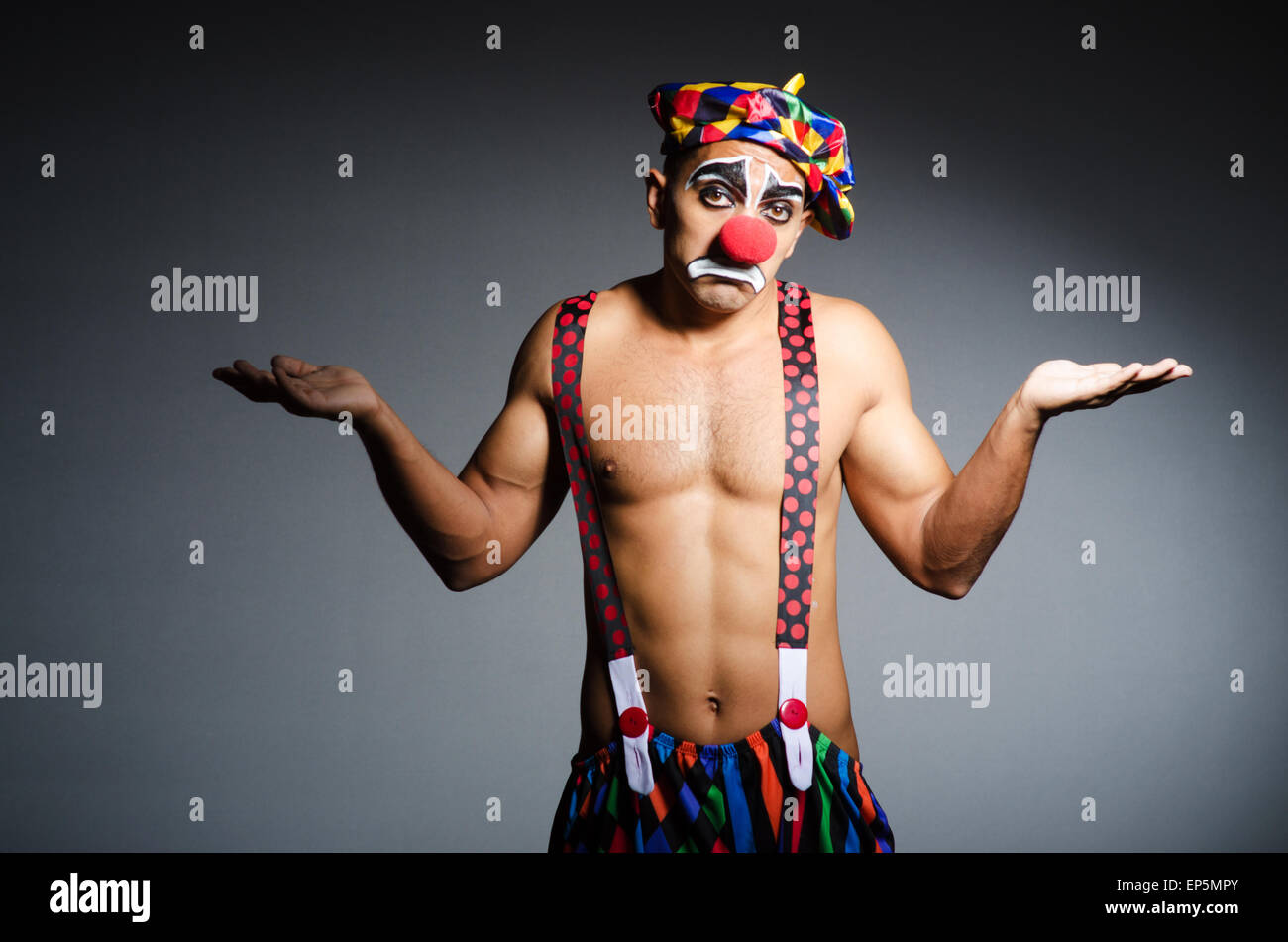 Sad clown against dark background Stock Photo - Alamy