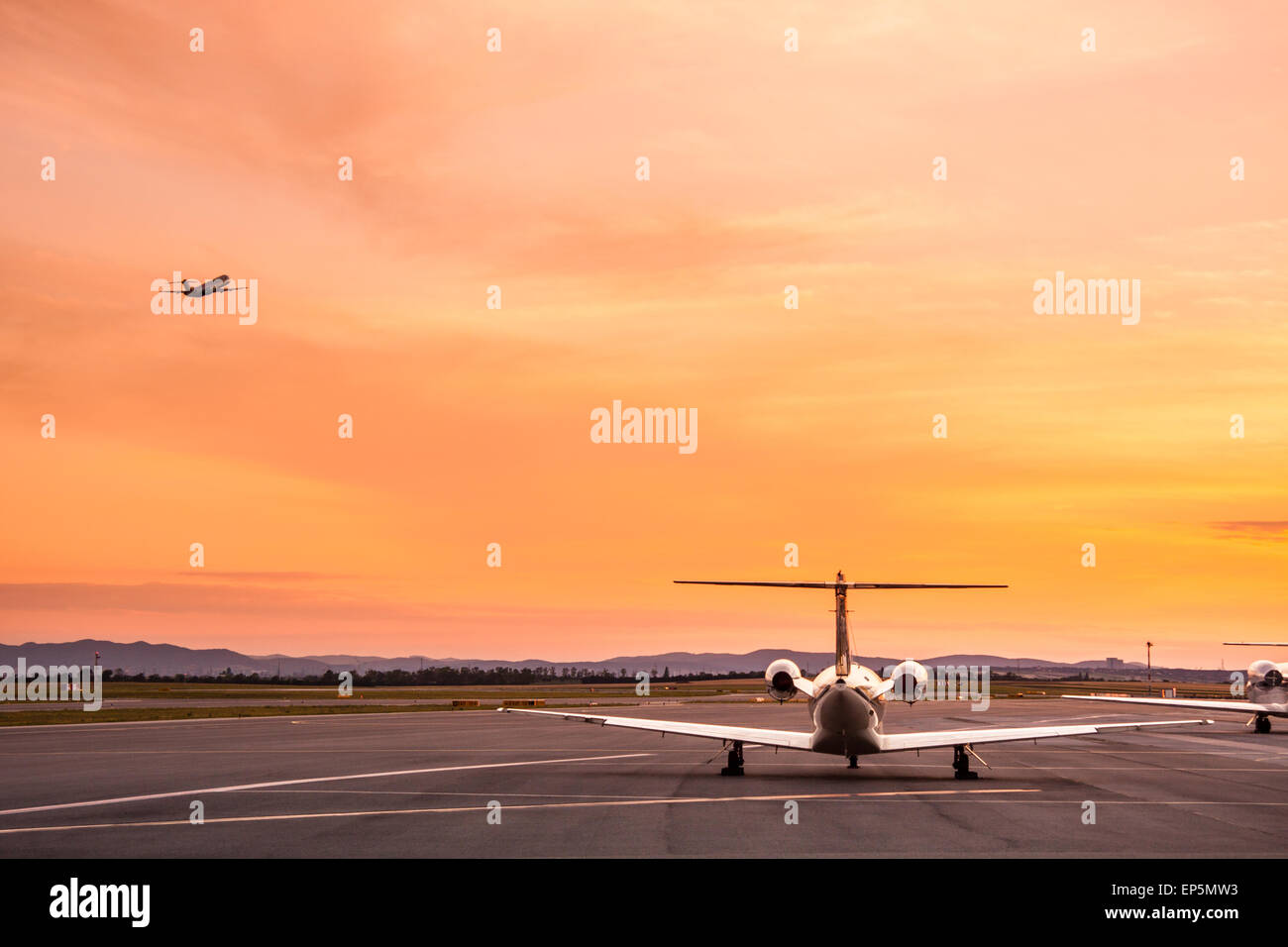 Airplane at sunset Stock Photo - Alamy