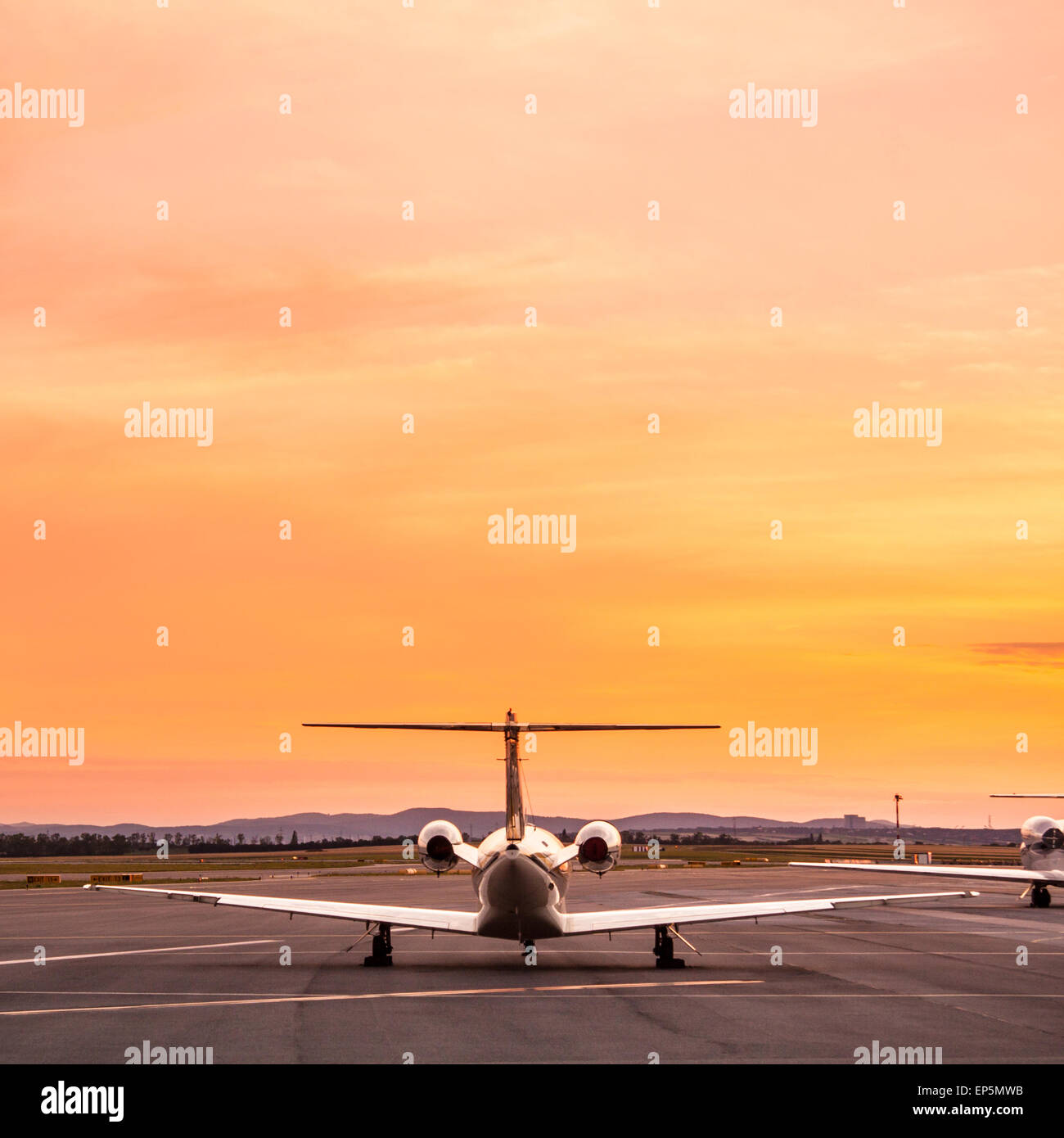 Airplane at sunset Stock Photo - Alamy