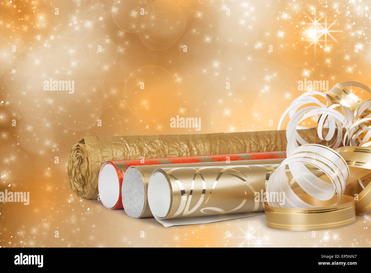 Rolls of multicolored wrapping paper for gifts with a streamer on a ...