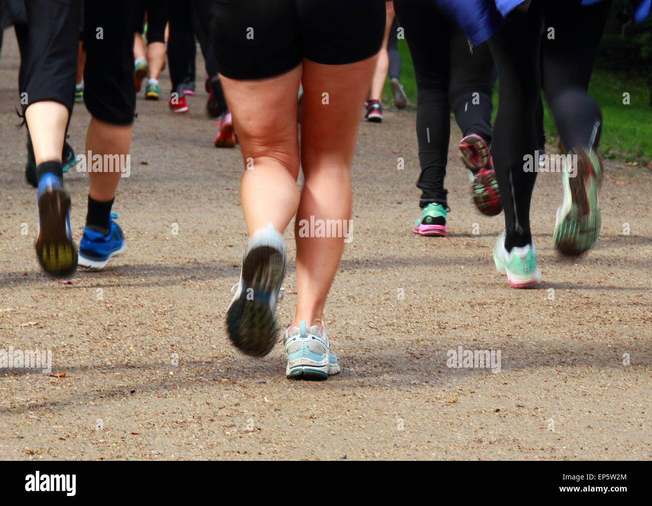 Running rearguard of legs at a long distance race Stock Photo - Alamy