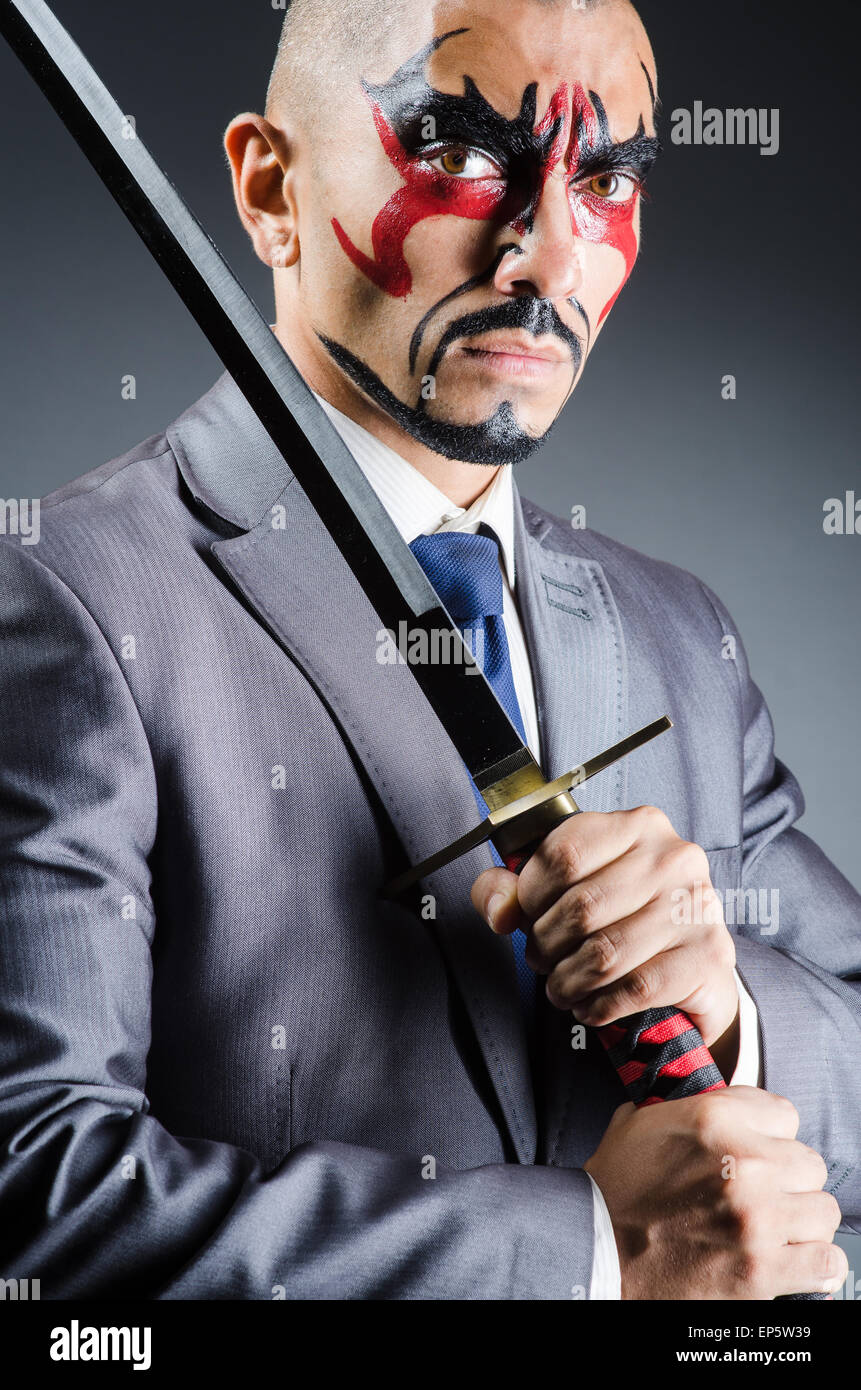 Man with face paint and sword Stock Photo - Alamy