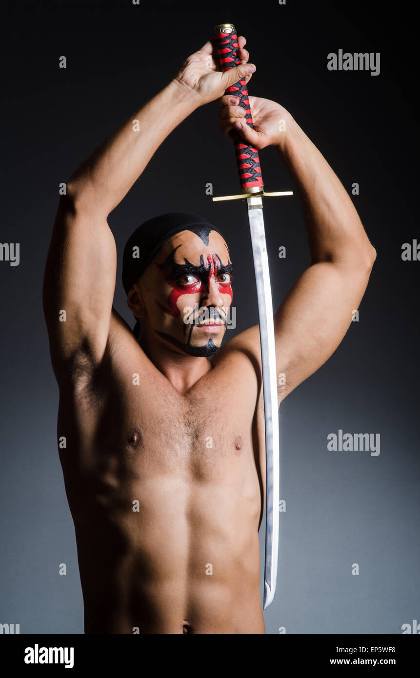 Man with sword and face paint Stock Photo - Alamy