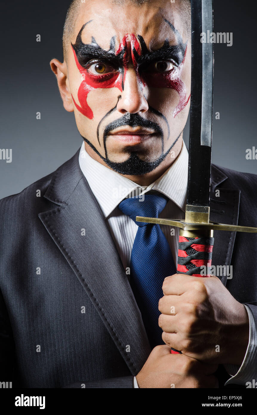 Man with face paint and sword Stock Photo - Alamy