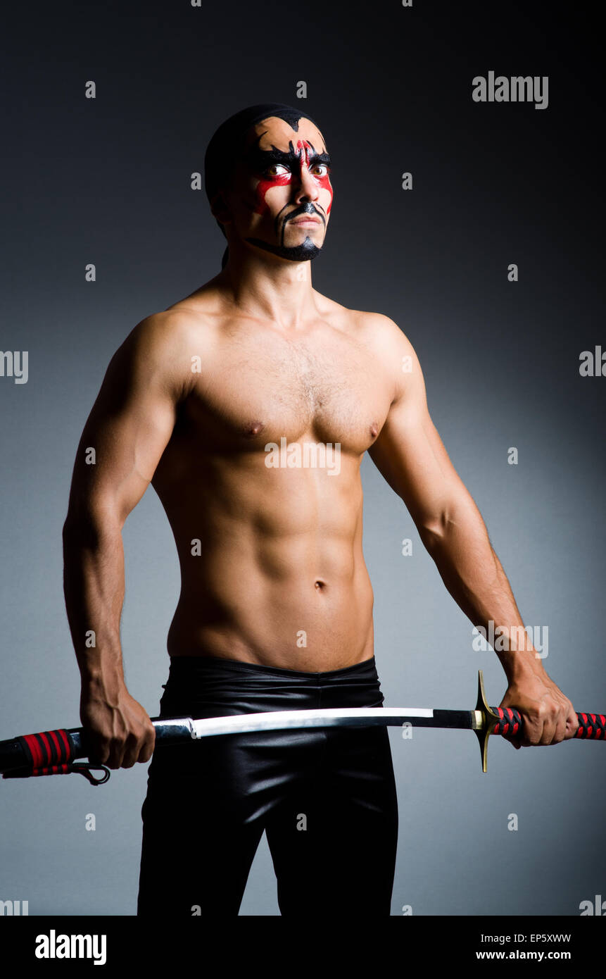 Man with sword and face paint Stock Photo - Alamy
