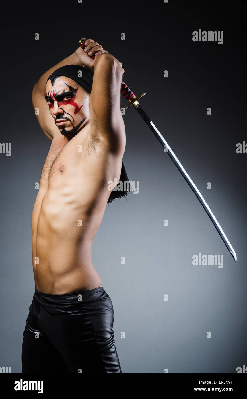 Man with sword and face paint Stock Photo - Alamy