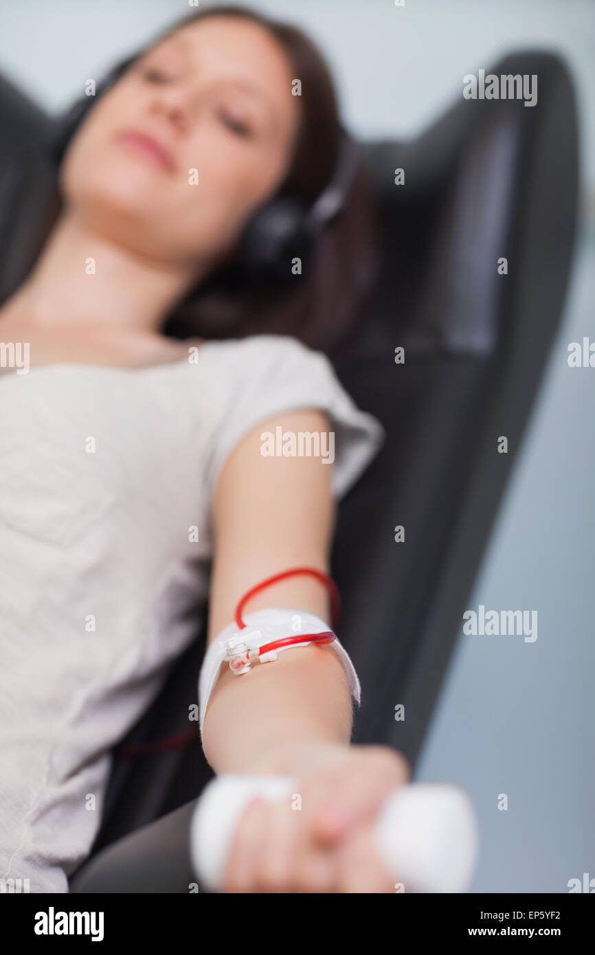 Patient listening to music while giving her blood in a hospital Stock ...