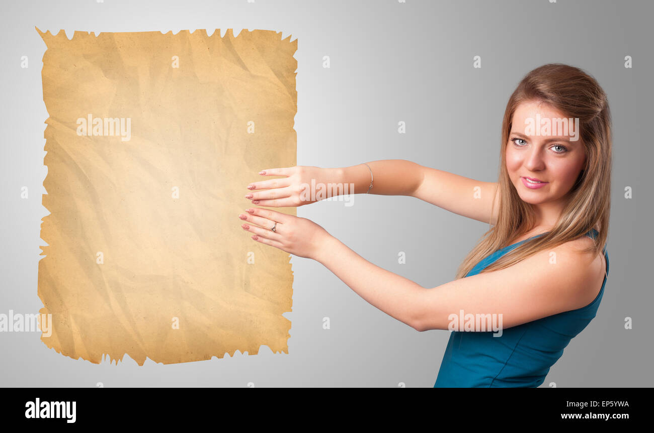 Young girl presenting old paper copy space Stock Photo - Alamy