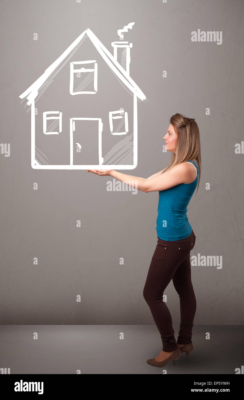 Young lady holding a huge drawn house Stock Photo - Alamy