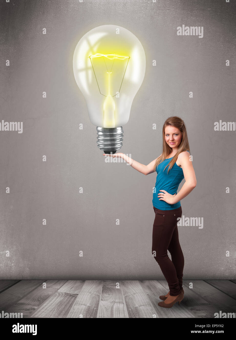 Beautiful lady holding realistic 3d light bulb Stock Photo - Alamy