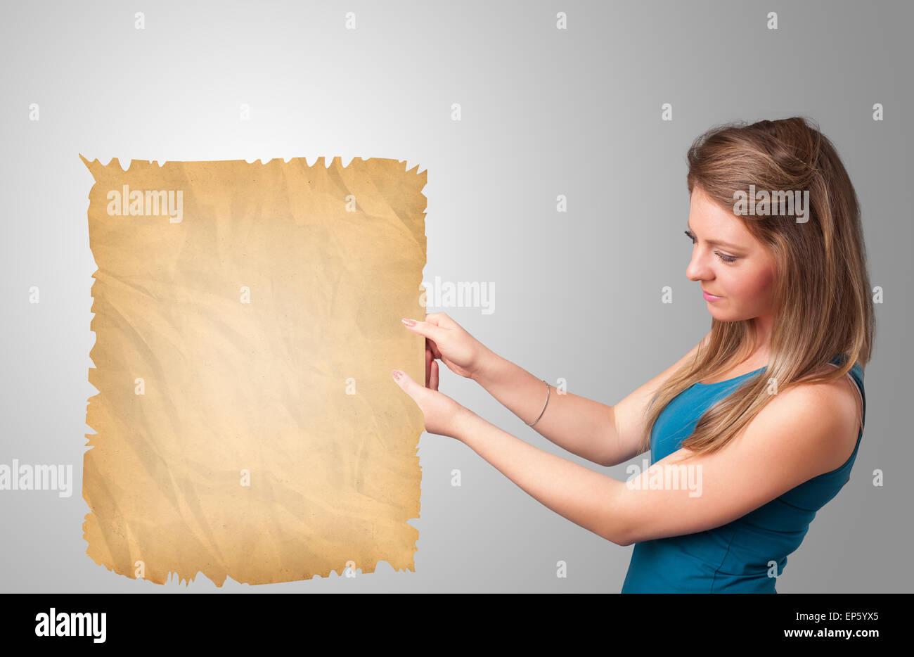 Young girl presenting old paper copy space Stock Photo - Alamy