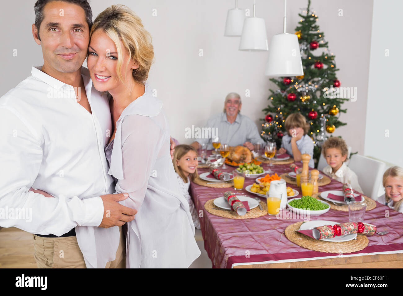 Husband and wife standing by the dinner table Stock Photo - Alamy