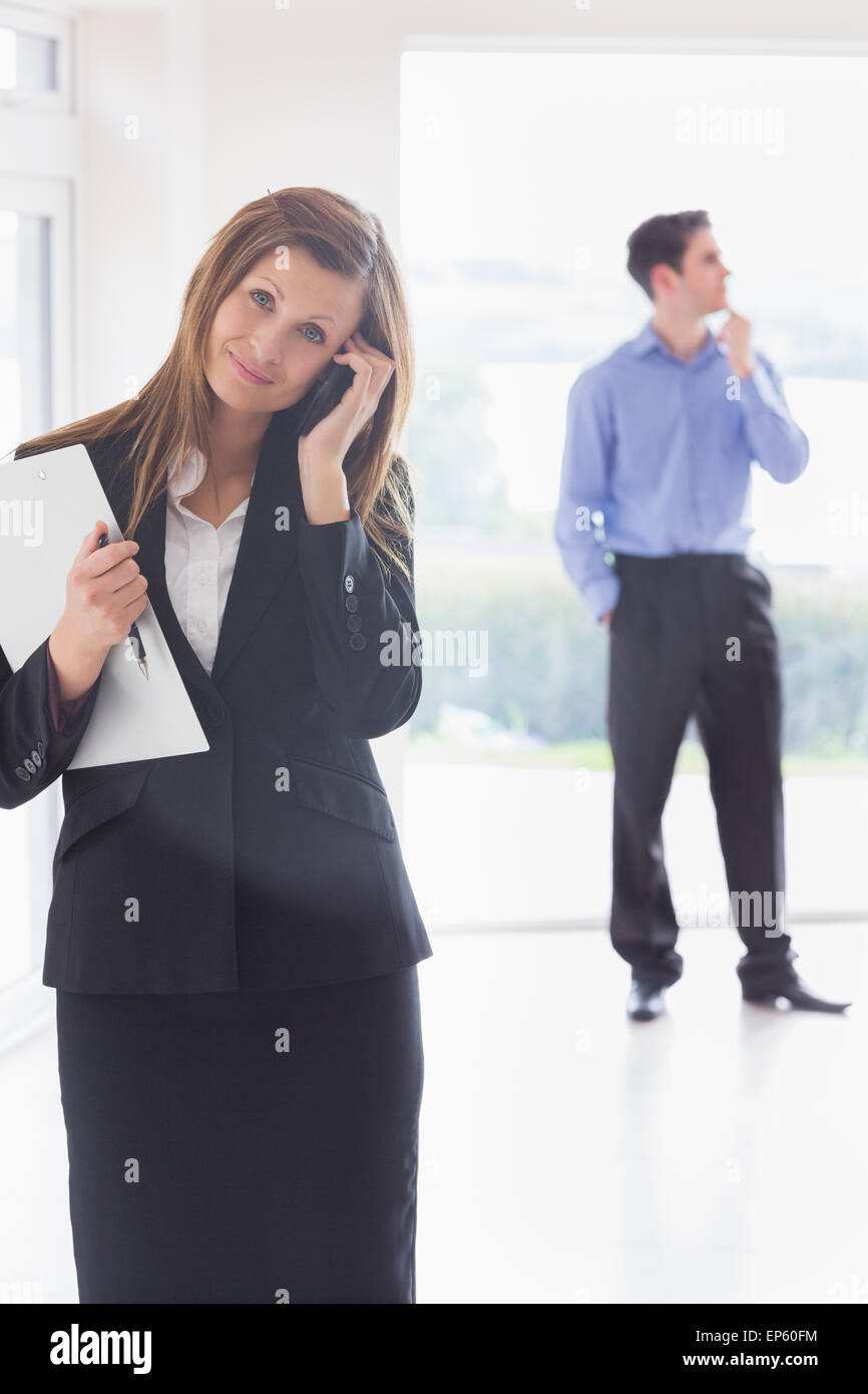 Woman calling while man looking around and deciding Stock Photo - Alamy