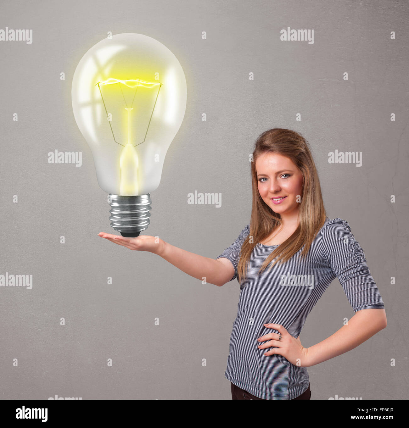 Beautiful lady holding realistic 3d light bulb Stock Photo - Alamy