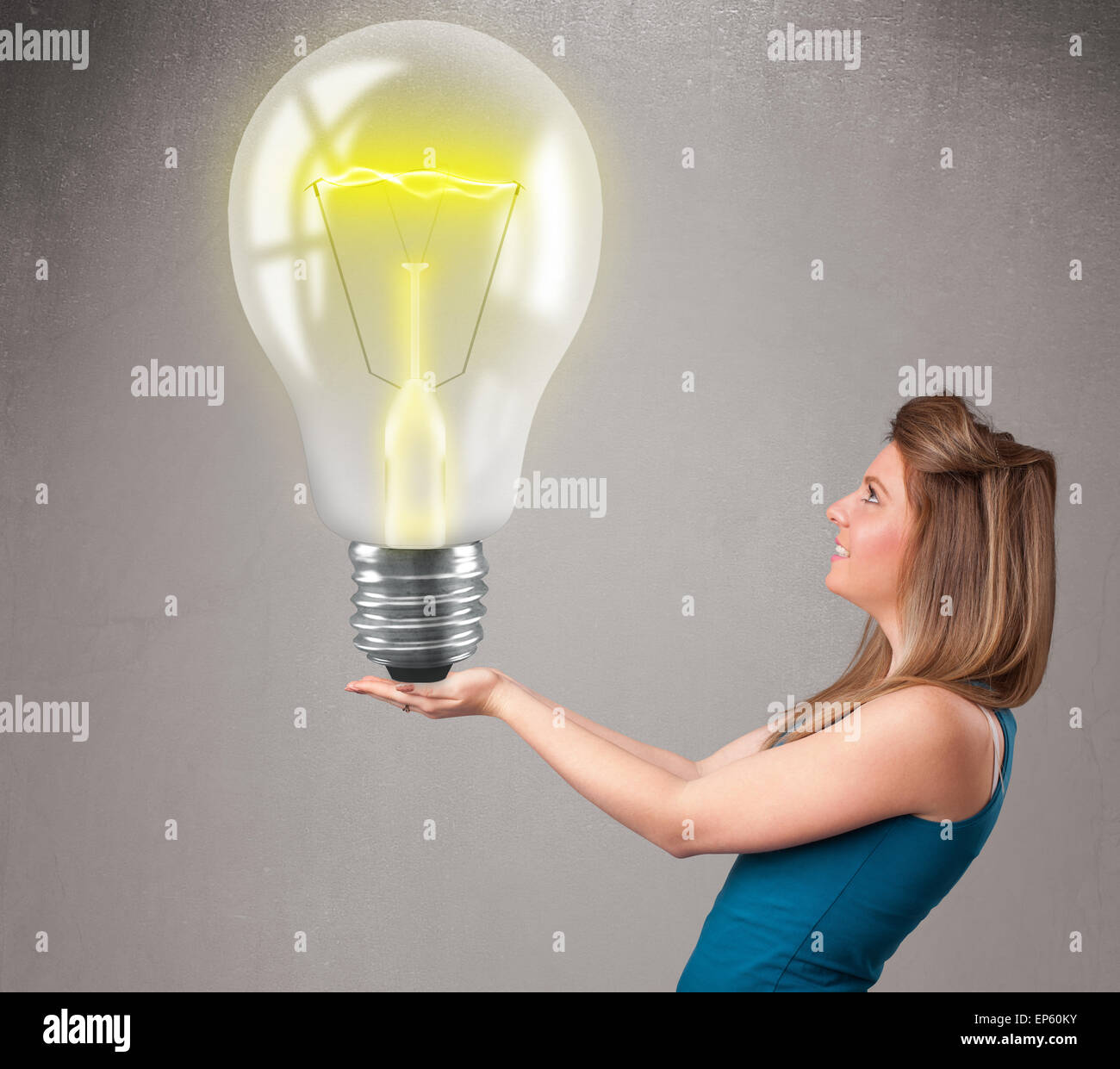 Beautiful lady holding realistic 3d light bulb Stock Photo - Alamy