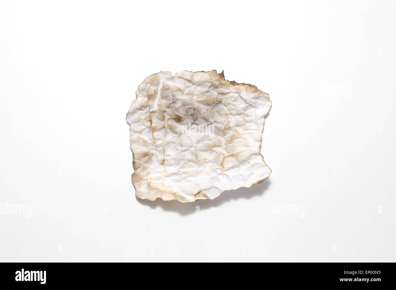 burn of crumpled paper on a white background Stock Photo - Alamy