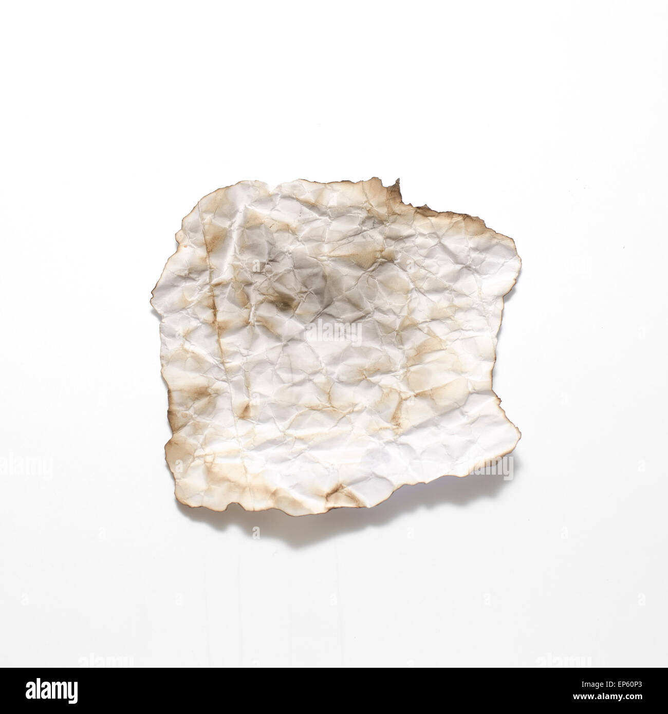 burn of crumpled paper on a white background Stock Photo - Alamy