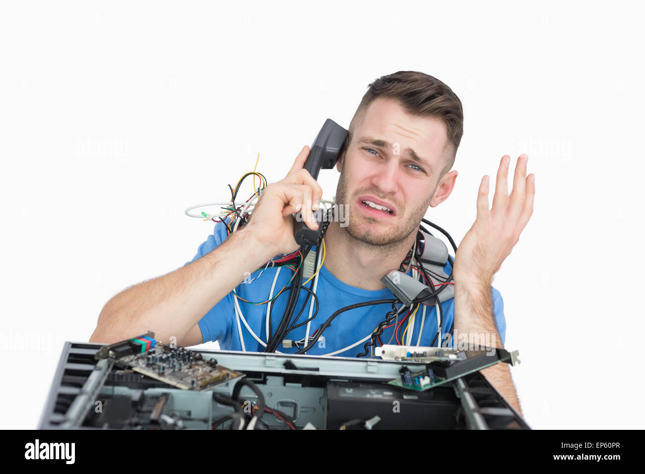 Frustrated computer engineer on call in front of open cpu Stock Photo ...