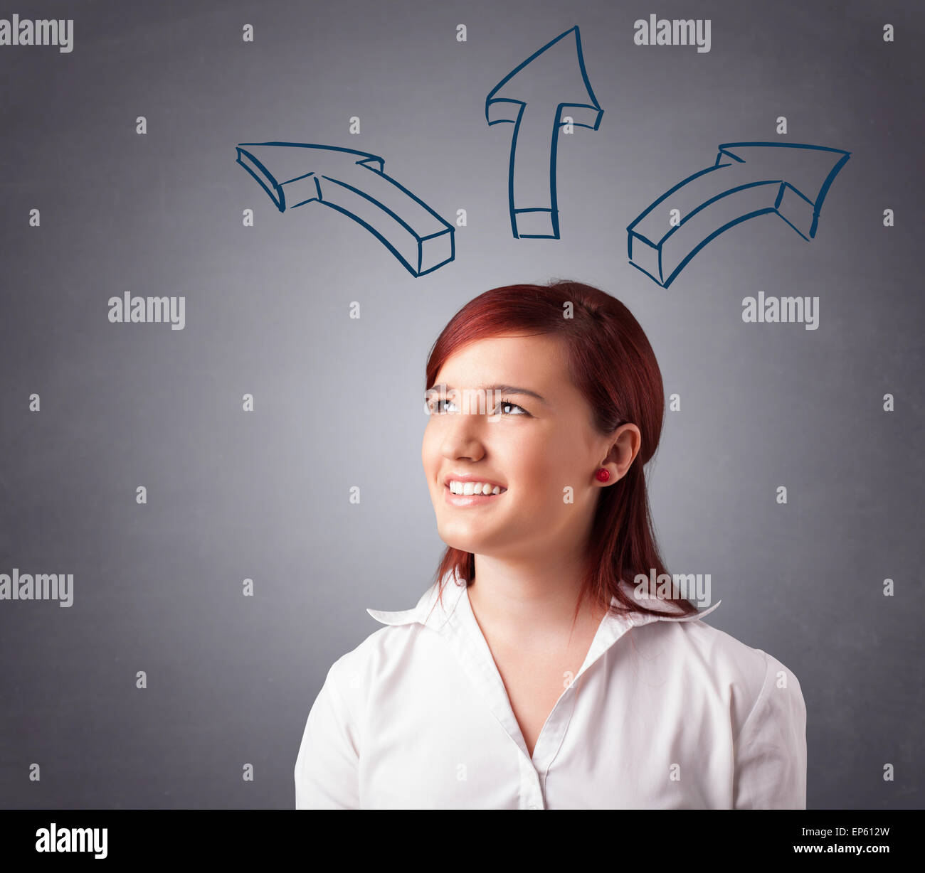Pretty lady thinking with arrows overhead Stock Photo - Alamy