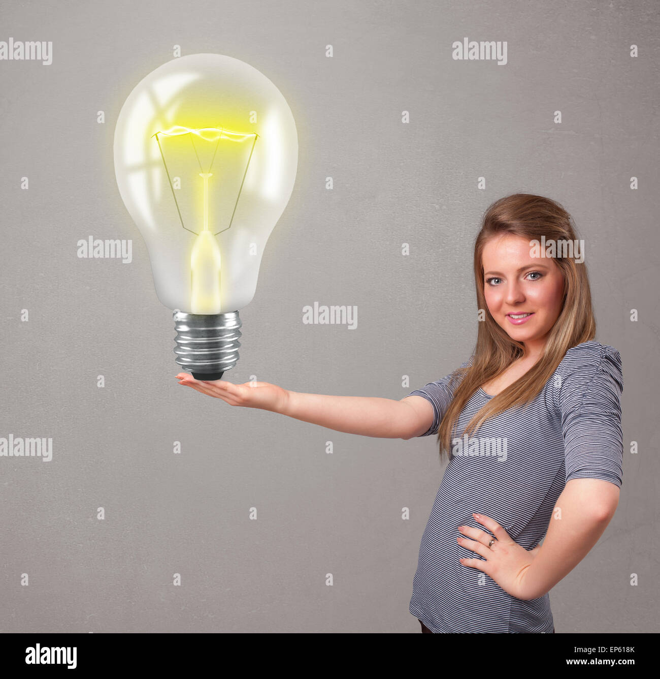 Beautiful lady holding realistic 3d light bulb Stock Photo - Alamy