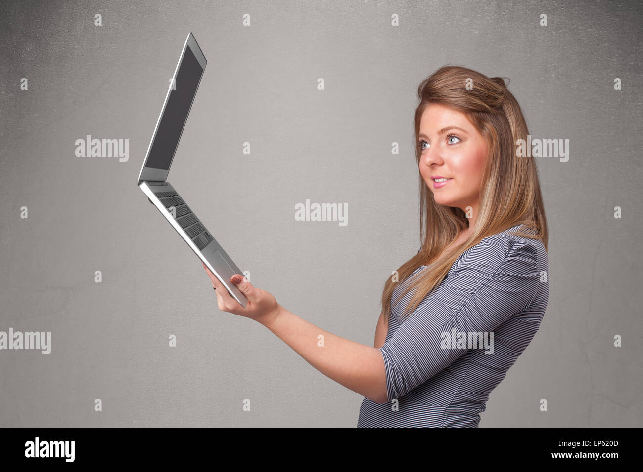 Young woman holding modern laptot Stock Photo - Alamy