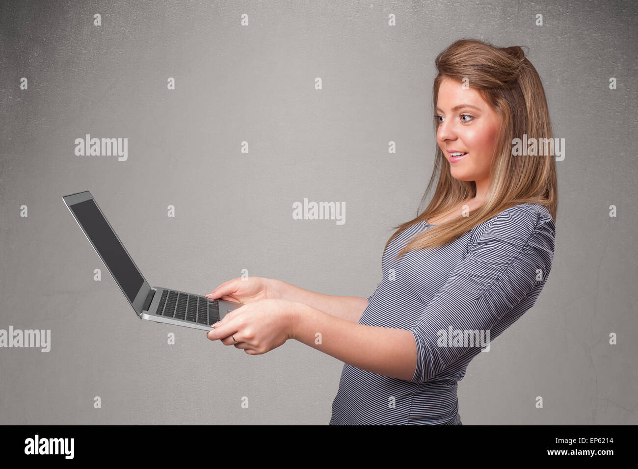 Young woman holding modern laptot Stock Photo - Alamy