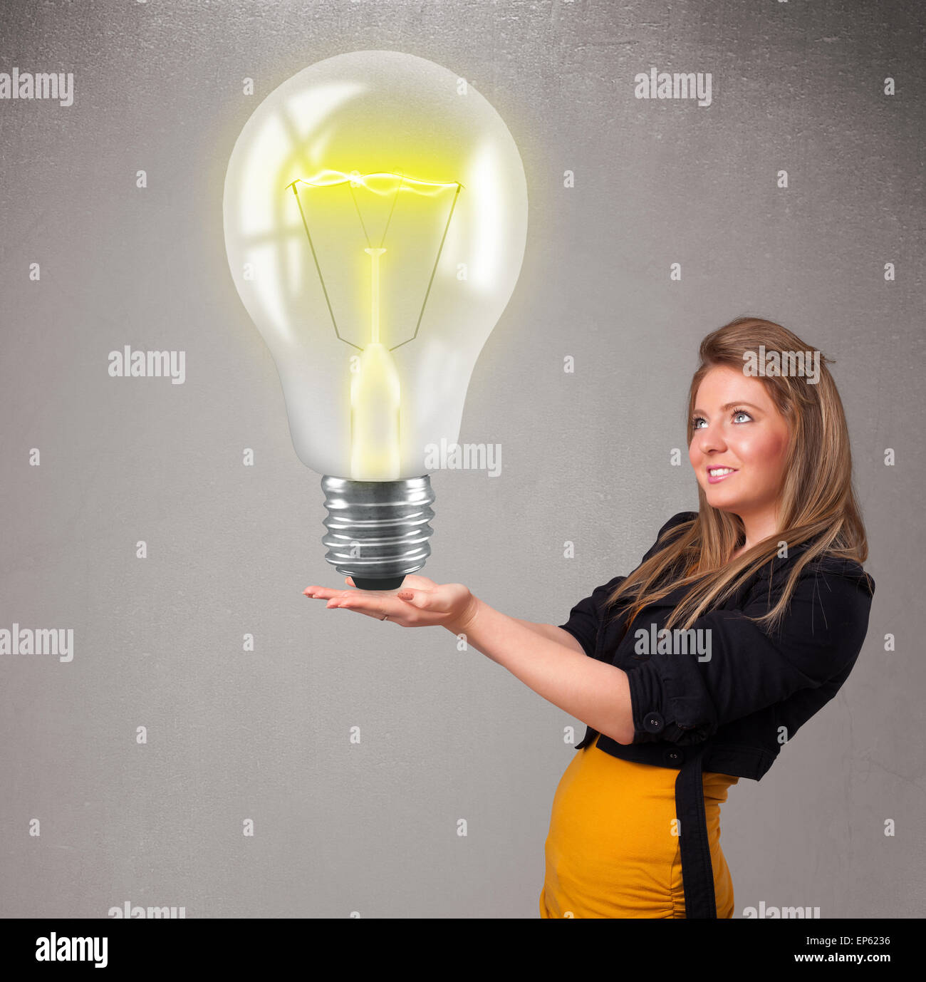 Beautiful lady holding realistic 3d light bulb Stock Photo - Alamy