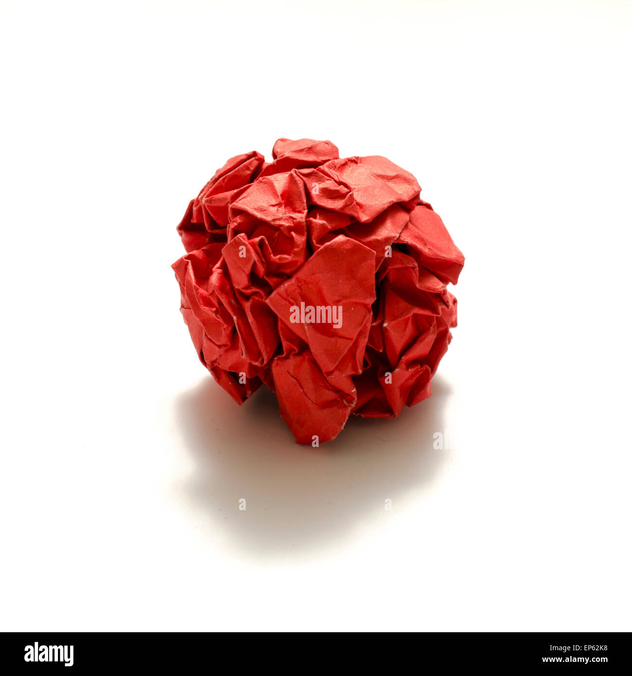 red crumpled paper ball on a white background Stock Photo - Alamy