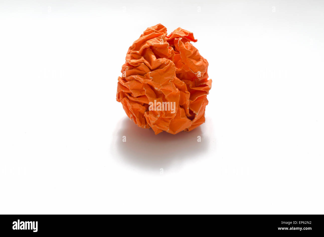 orange color crumpled paper ball on a white background Stock Photo - Alamy
