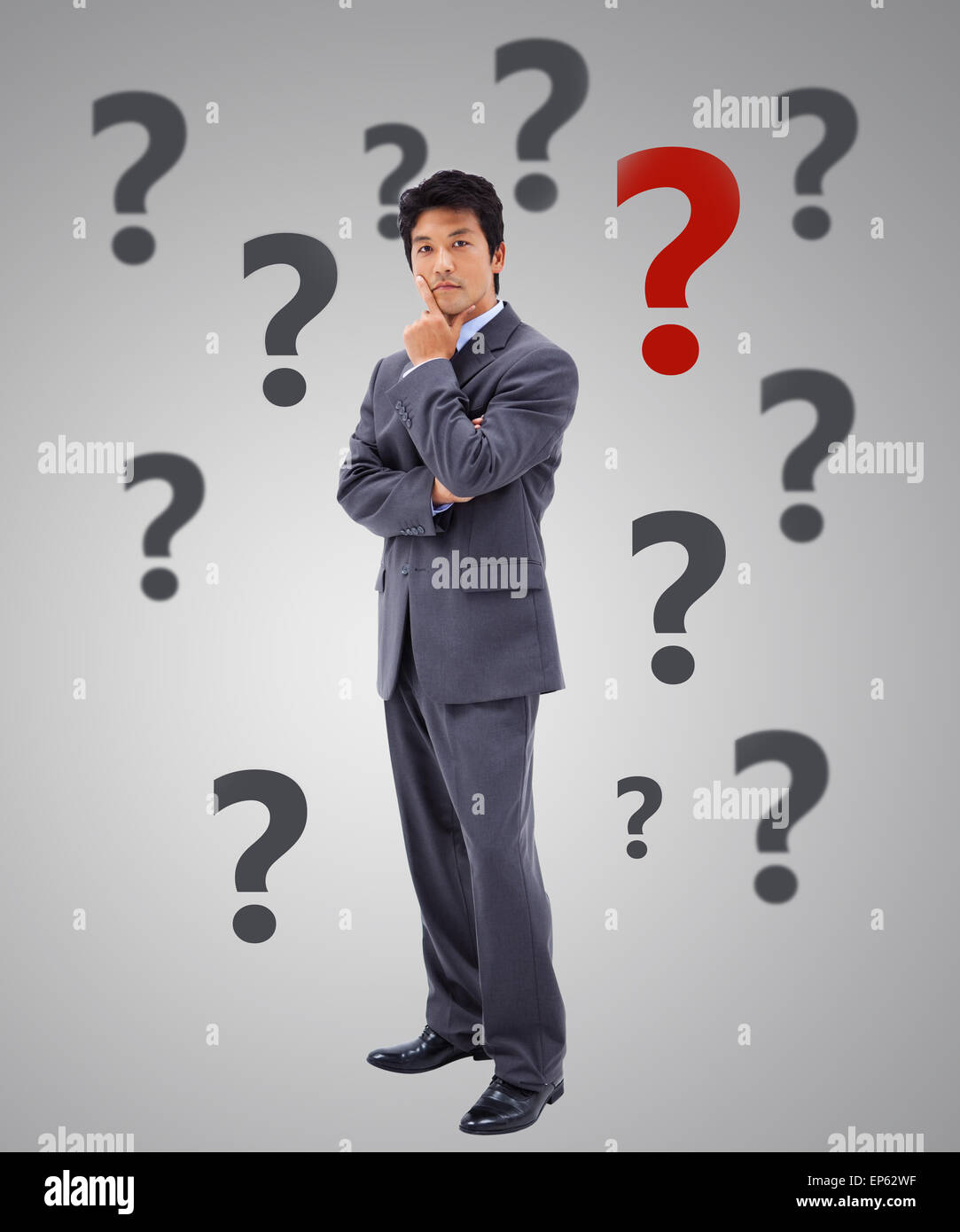 Businessman thinking surrounded by question marks Stock Photo - Alamy