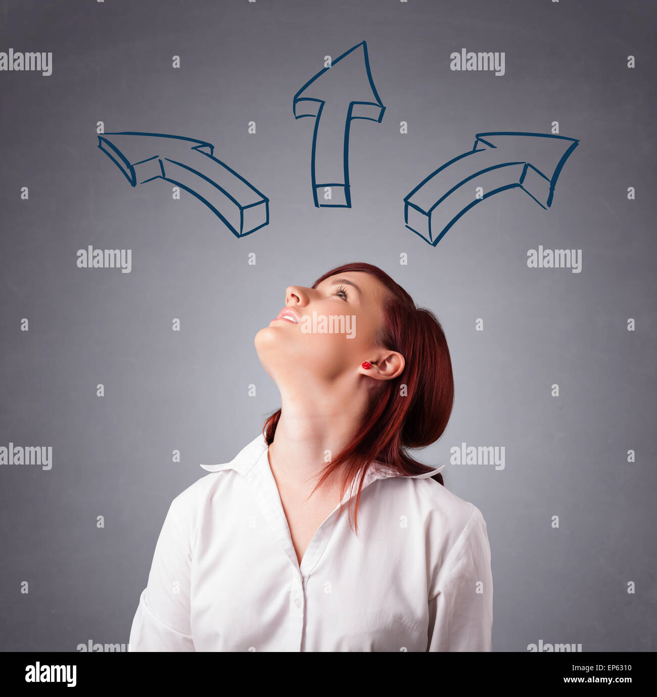 Pretty lady thinking with arrows overhead Stock Photo - Alamy
