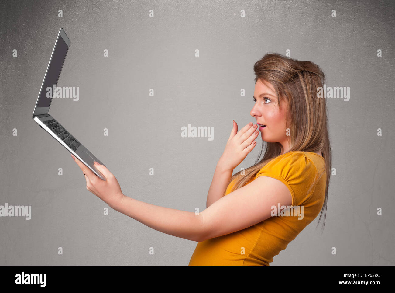 Young woman holding modern laptot Stock Photo - Alamy
