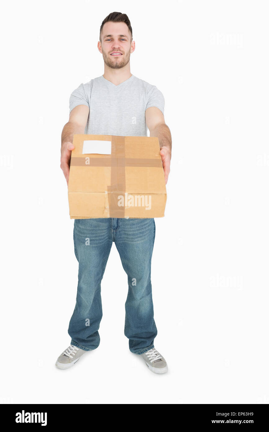 Portrait of young man giving you a package box Stock Photo - Alamy