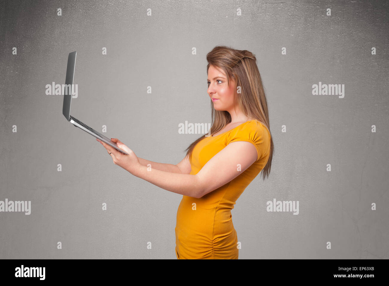 Young woman holding modern laptot Stock Photo - Alamy