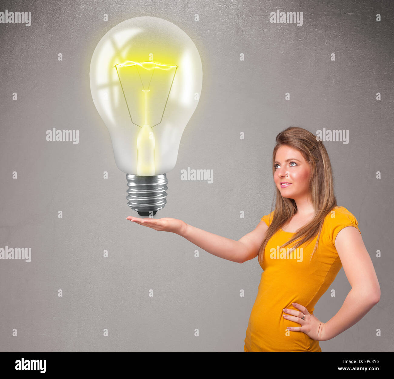 Beautiful lady holding realistic 3d light bulb Stock Photo - Alamy
