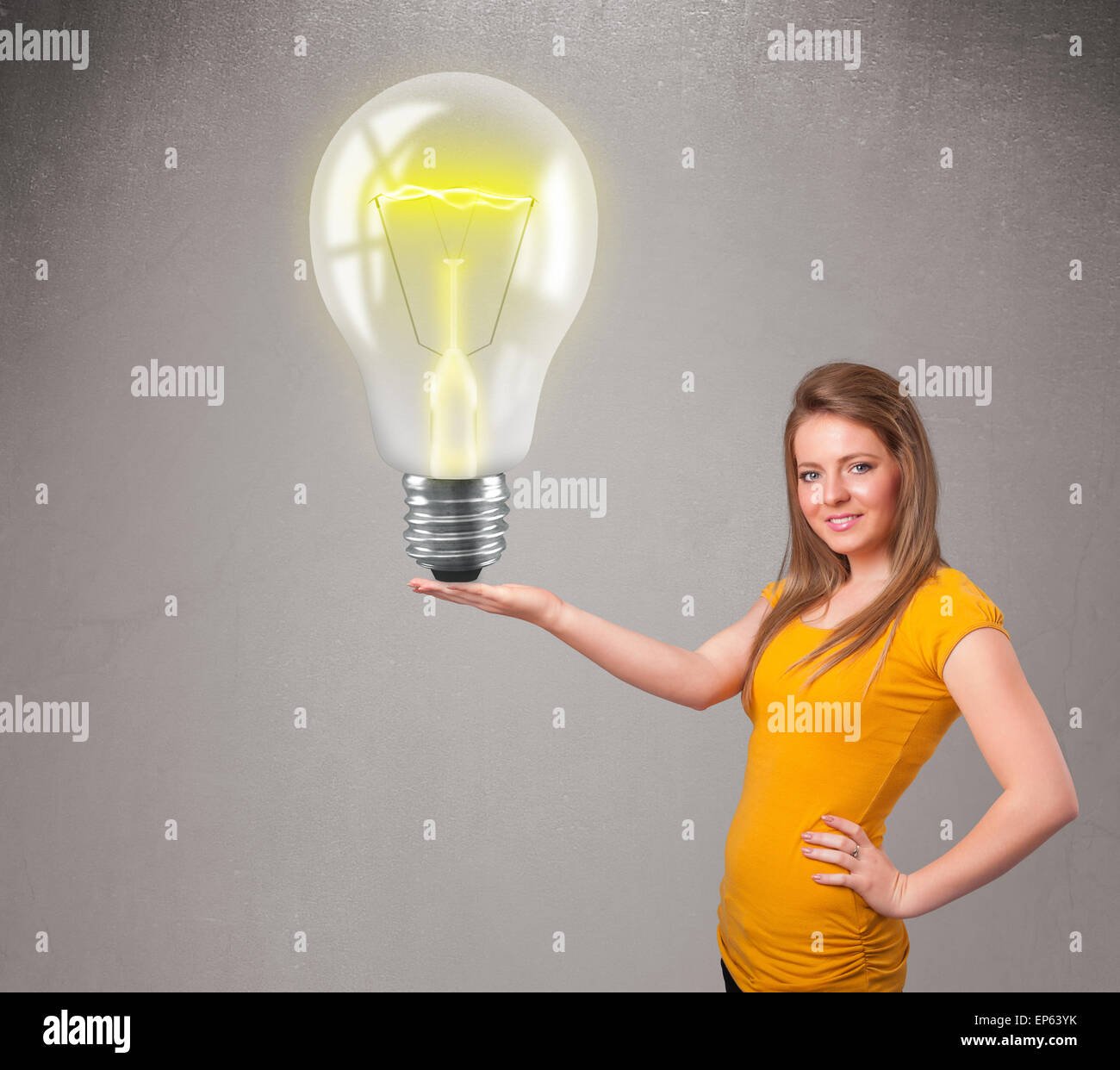 Beautiful lady holding realistic 3d light bulb Stock Photo - Alamy