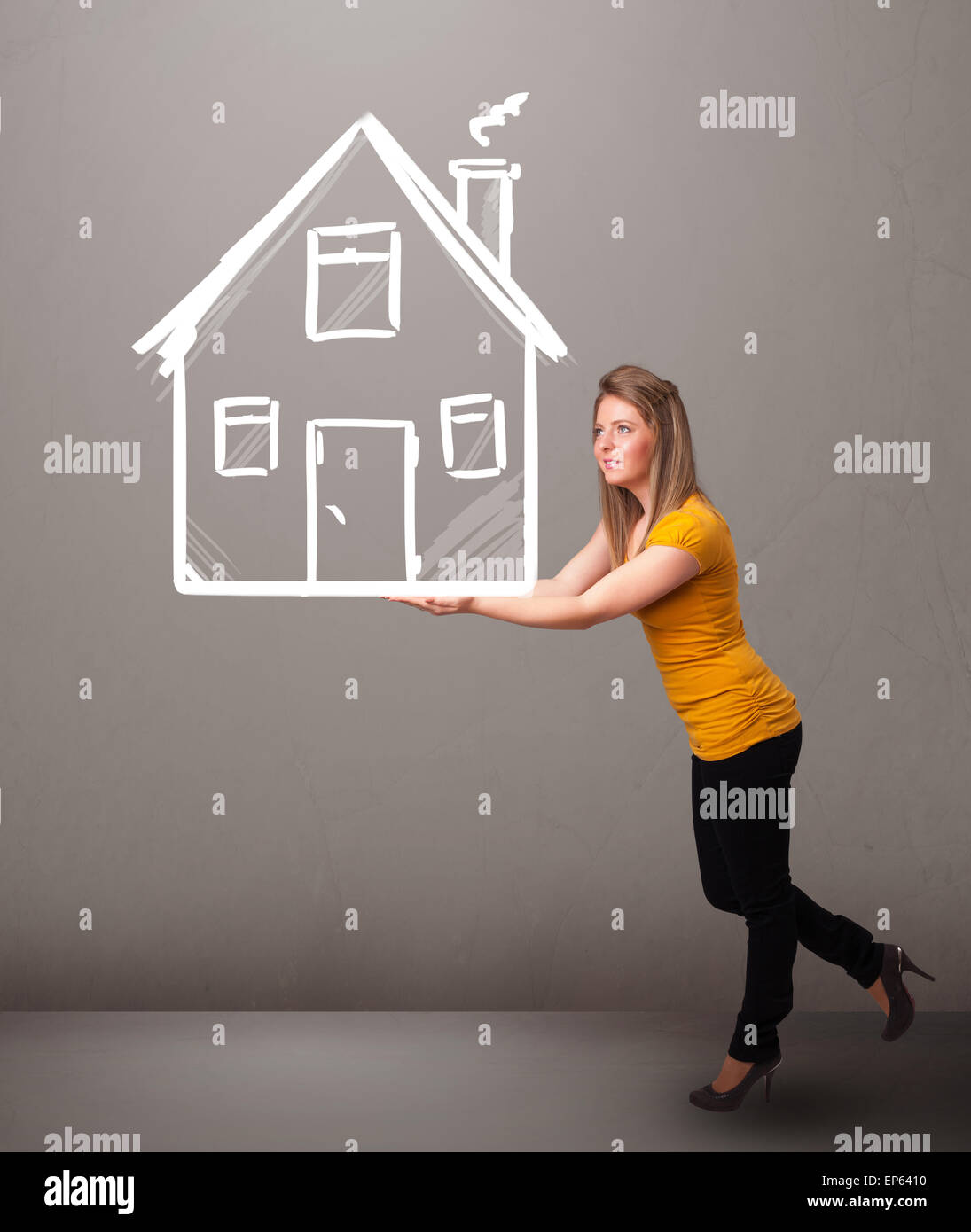 Young lady holding a huge drawn house Stock Photo - Alamy