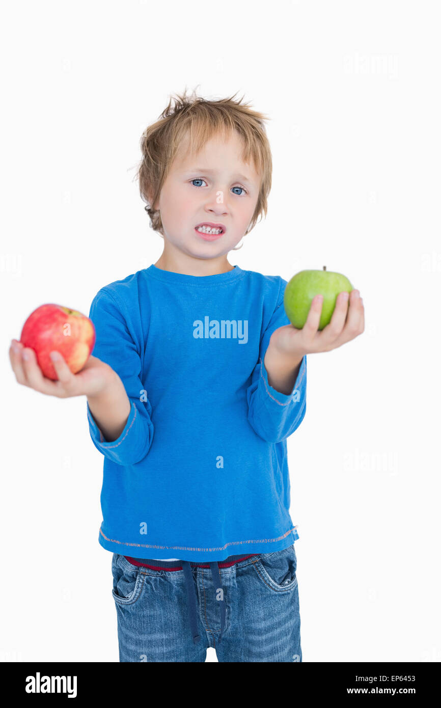 Portrait of young boy holding out green and red apples Stock Photo - Alamy