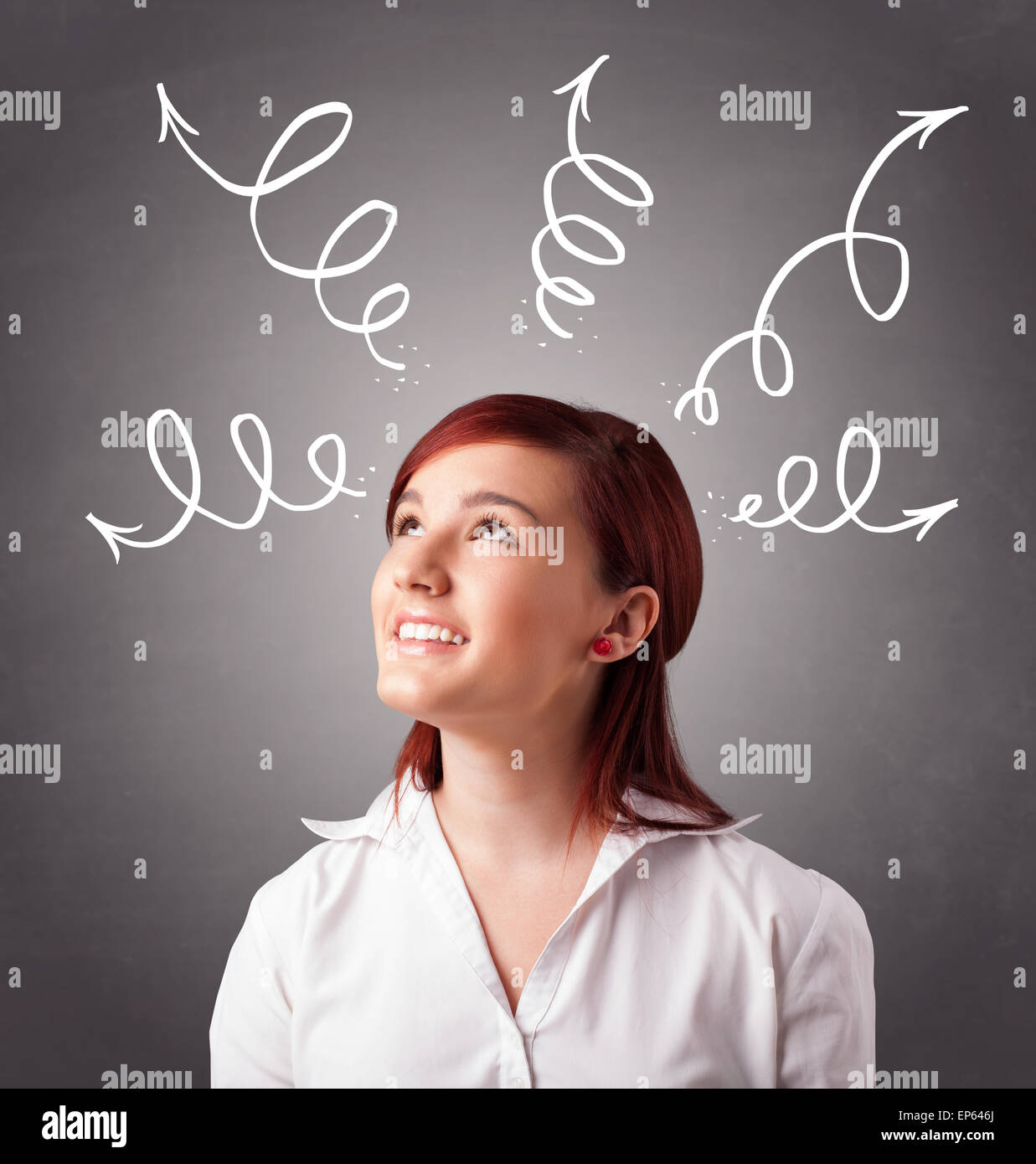 Young woman thinking with arrows overhead Stock Photo - Alamy