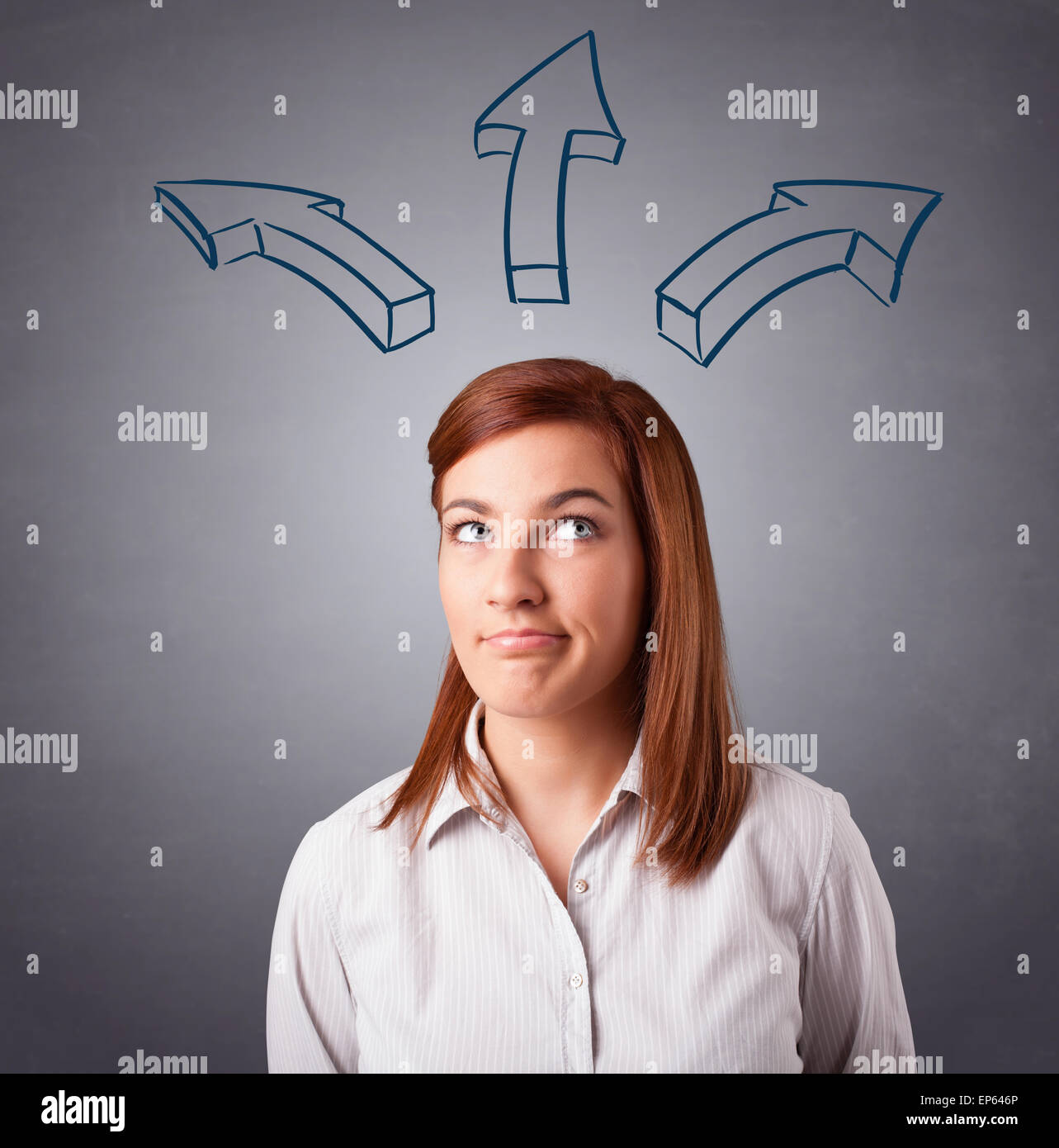 Pretty lady thinking with arrows overhead Stock Photo - Alamy