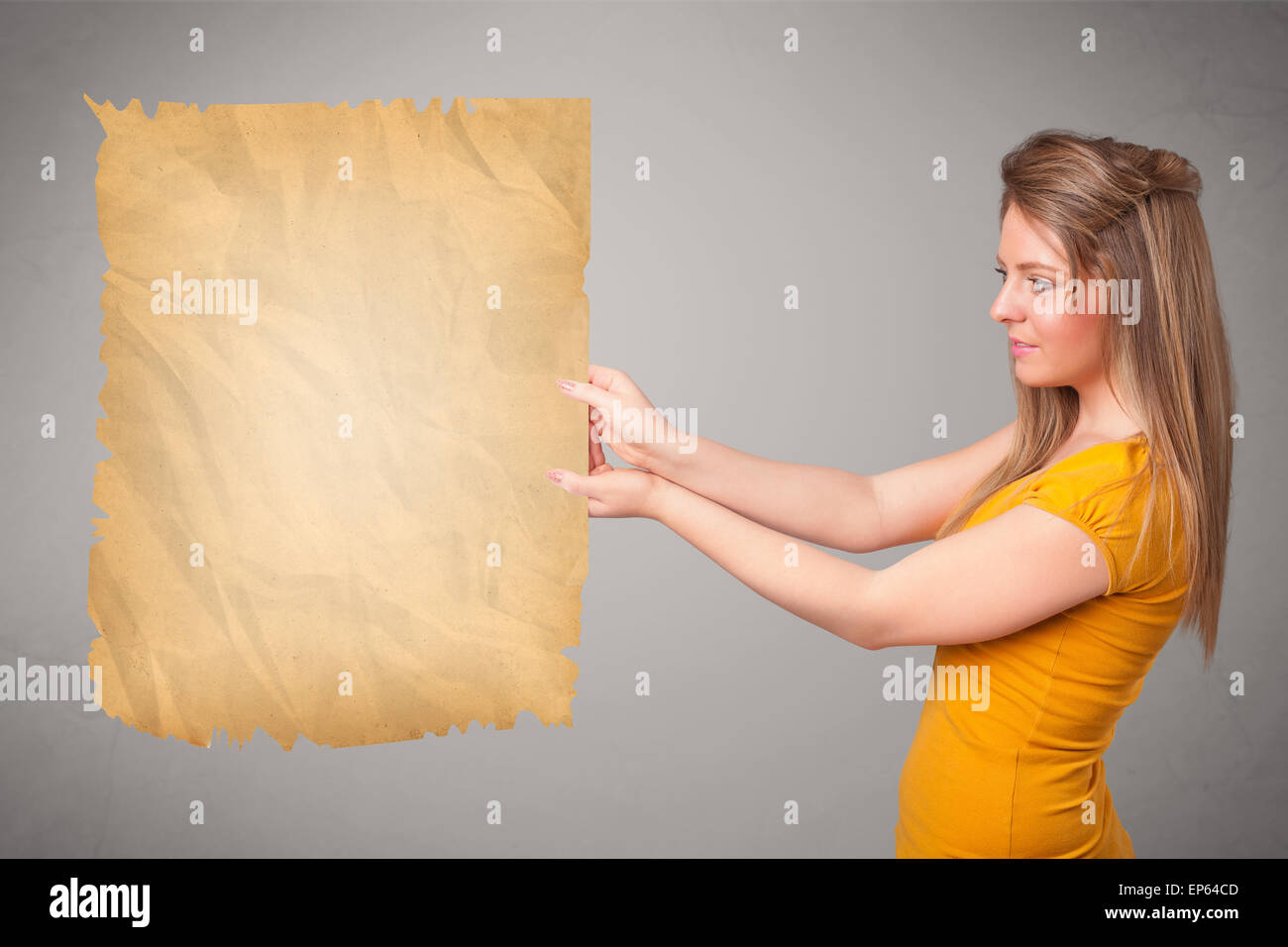Young girl presenting old paper copy space Stock Photo - Alamy