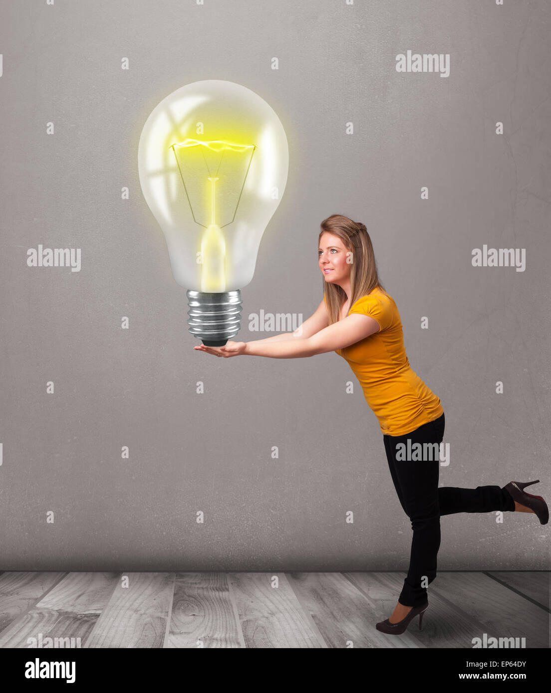 Beautiful lady holding realistic 3d light bulb Stock Photo - Alamy