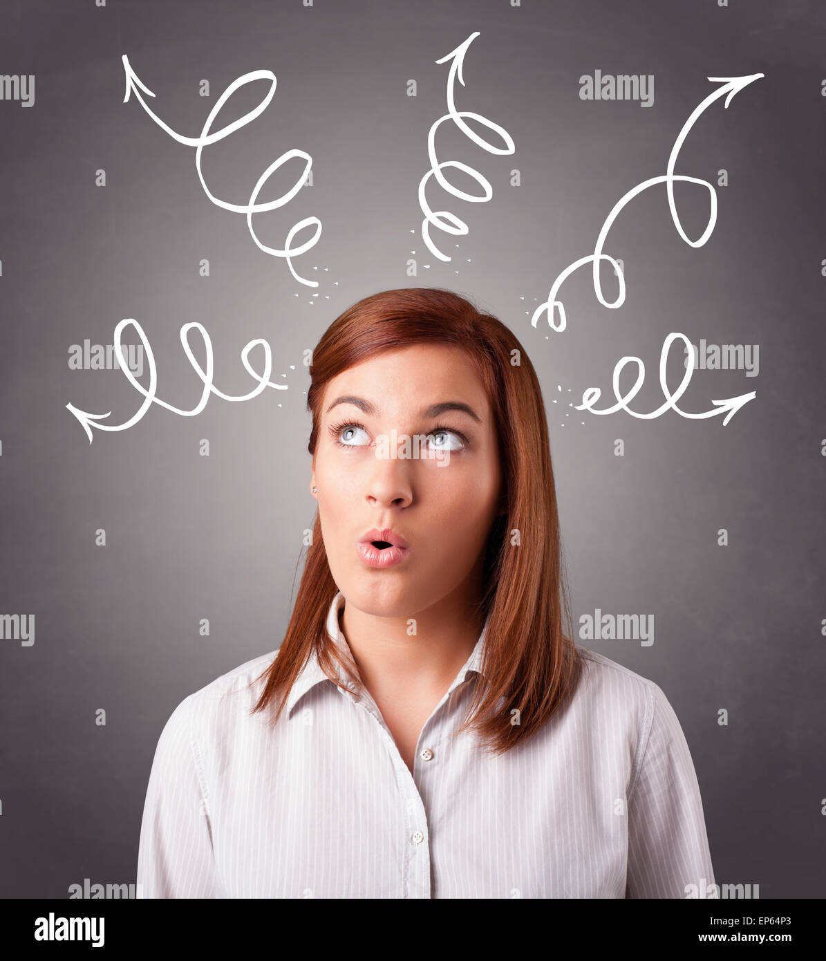 Young woman thinking with arrows overhead Stock Photo - Alamy