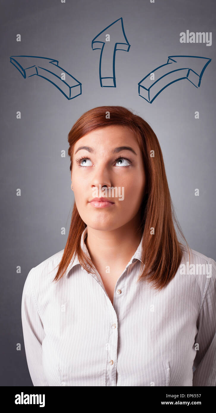 Pretty lady thinking with arrows overhead Stock Photo - Alamy