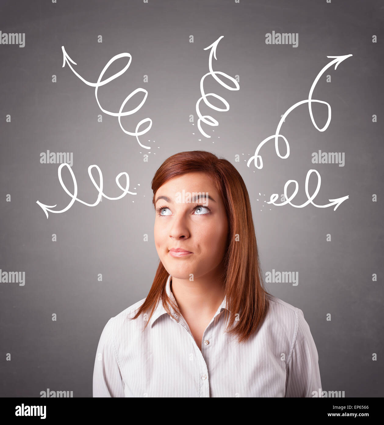 Young woman thinking with arrows overhead Stock Photo - Alamy