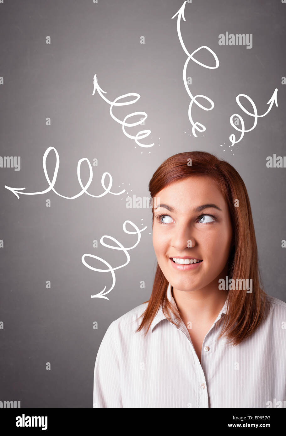 Young woman thinking with arrows overhead Stock Photo - Alamy