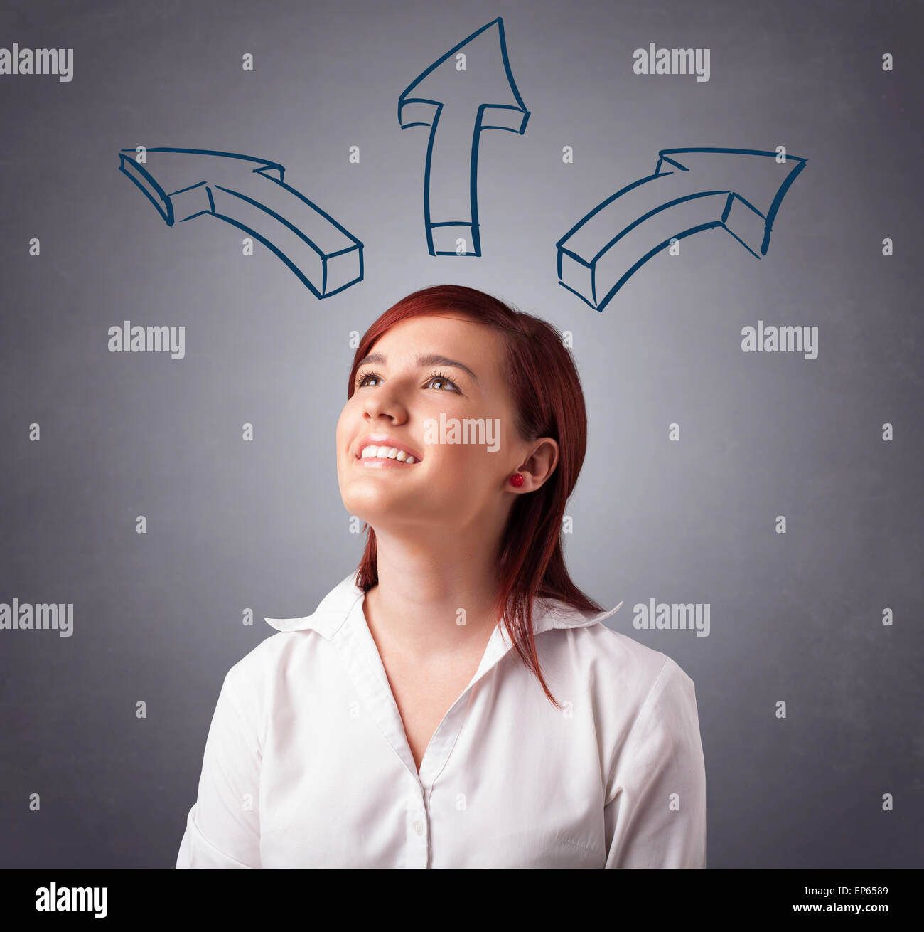 Pretty lady thinking with arrows overhead Stock Photo - Alamy