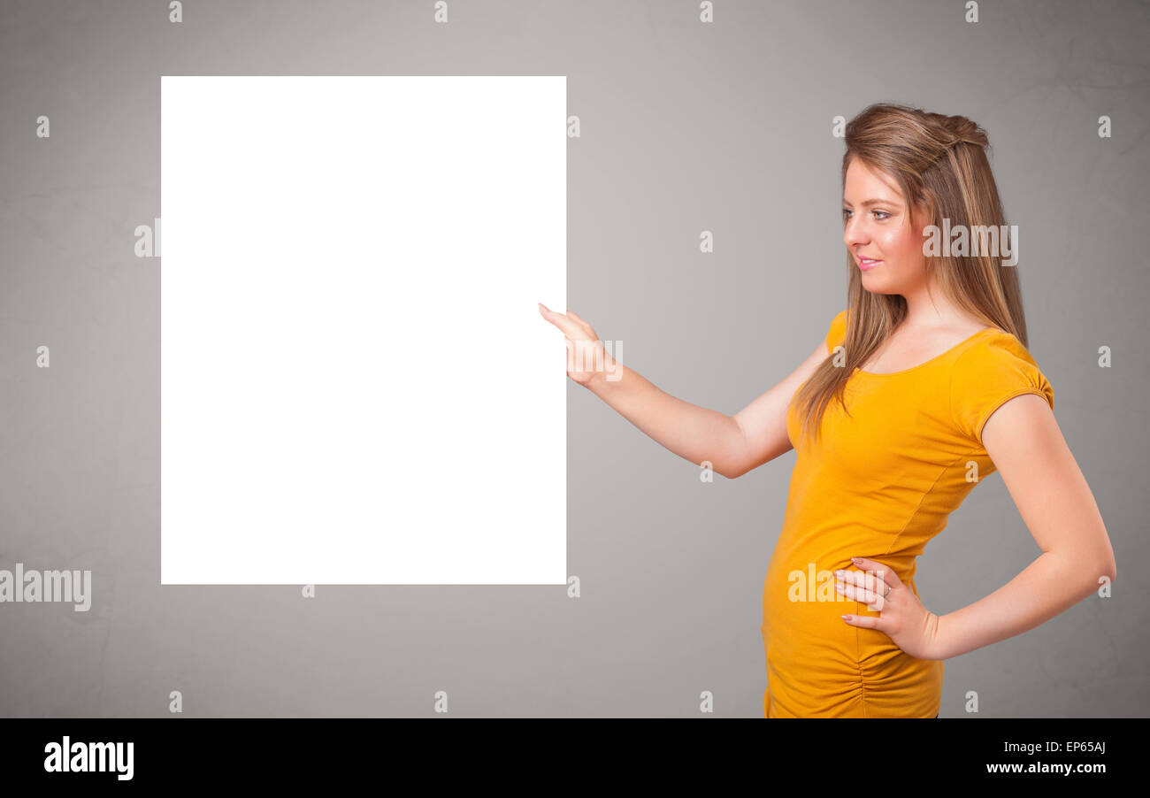 Young woman presenting white paper copy space Stock Photo - Alamy